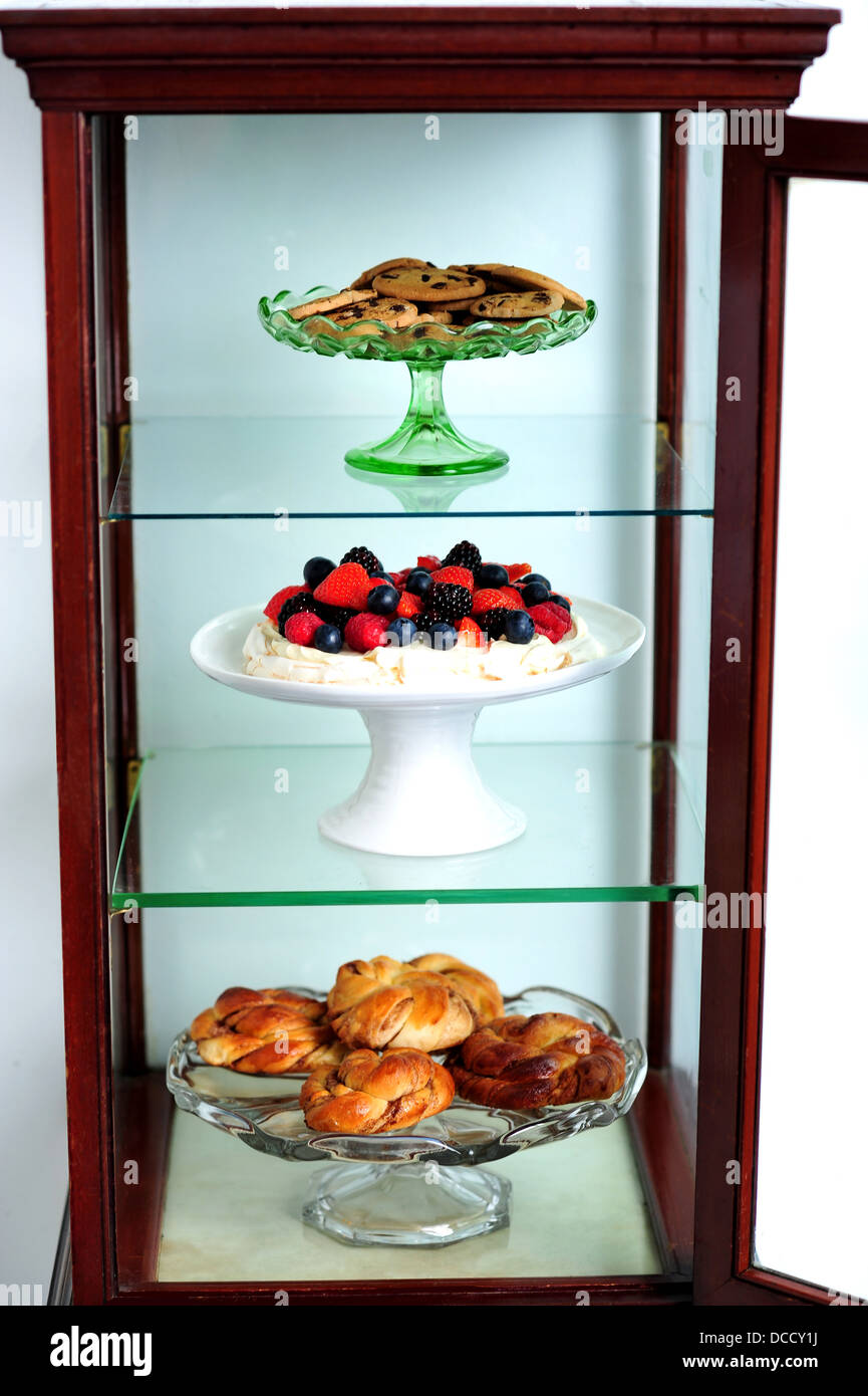 Shelf decorated by delicious desserts. Yummy three Stock Photo - Alamy