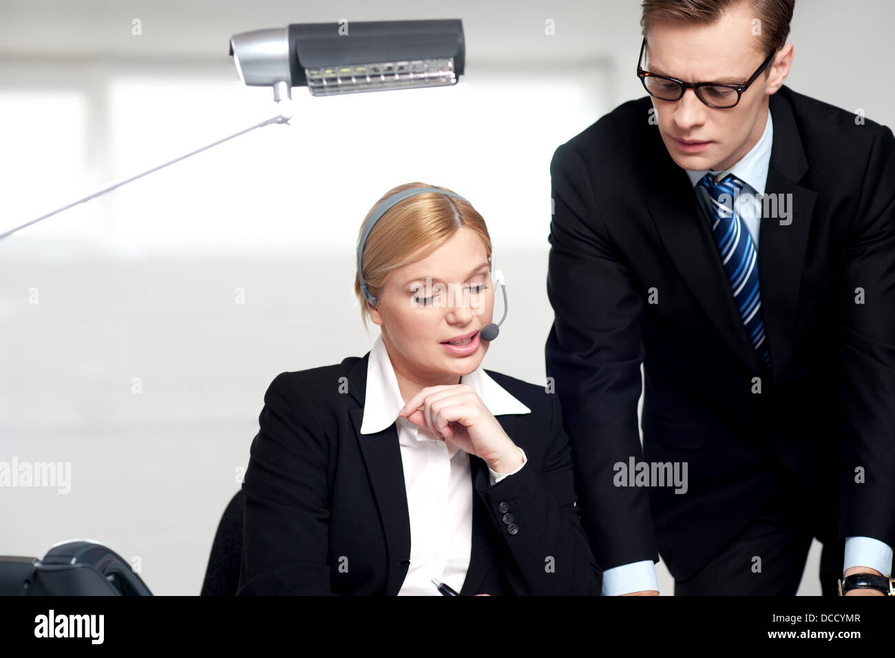 Female secretary explaining to boss in the office Stock Photo - Alamy