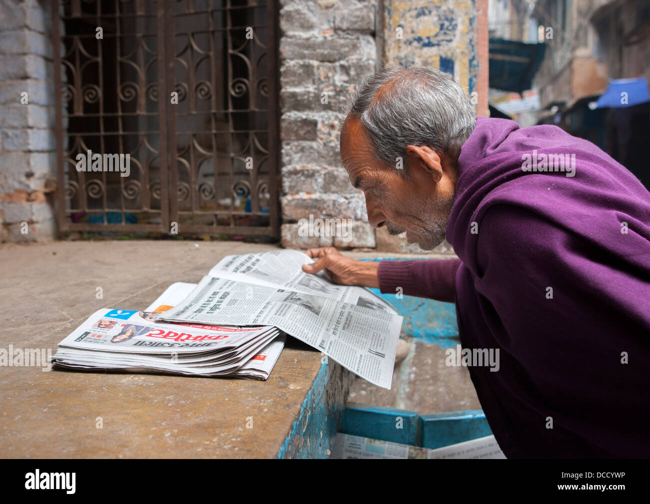 Old Man Reading A Newspaper In The Street, Varanasi, India Stock Photo ...
