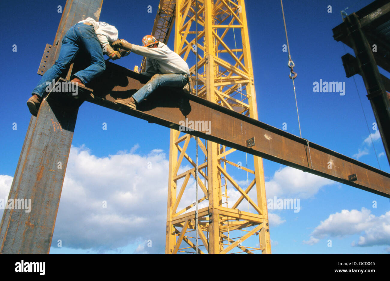 Ironworkers connecting steel beams Stock Photo - Alamy