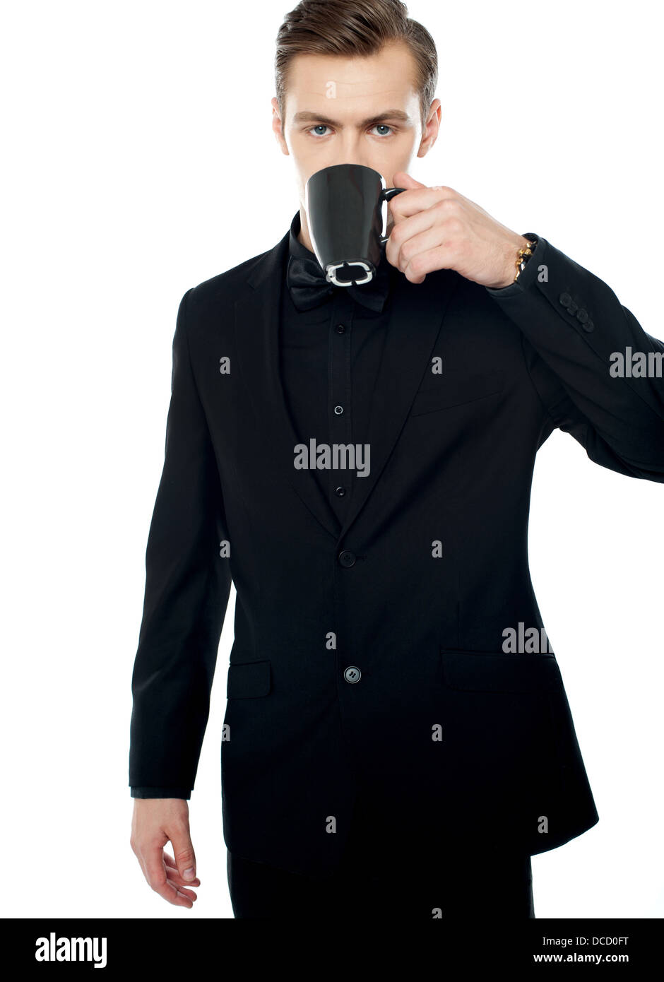 Smart young man drinking coffee in black cup over white background ...