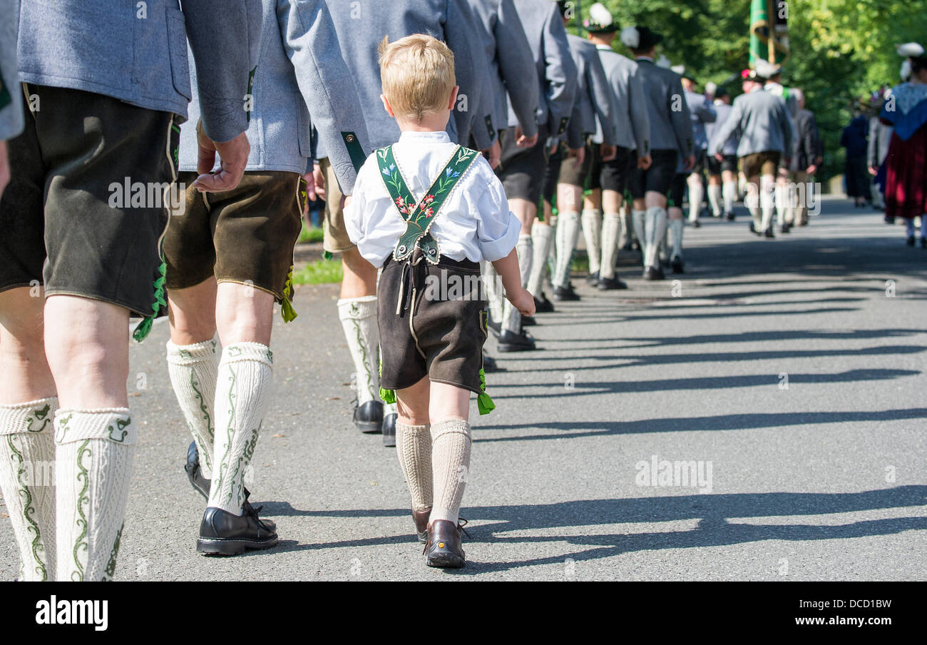 Participants in traditional costumes march during the traditional ...