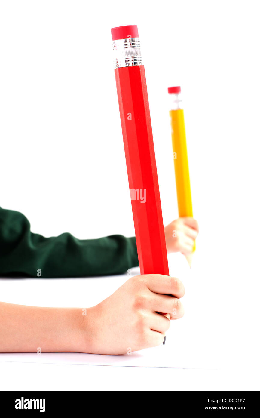 Two girls hands holding big pencil. Closeup shot Stock Photo - Alamy