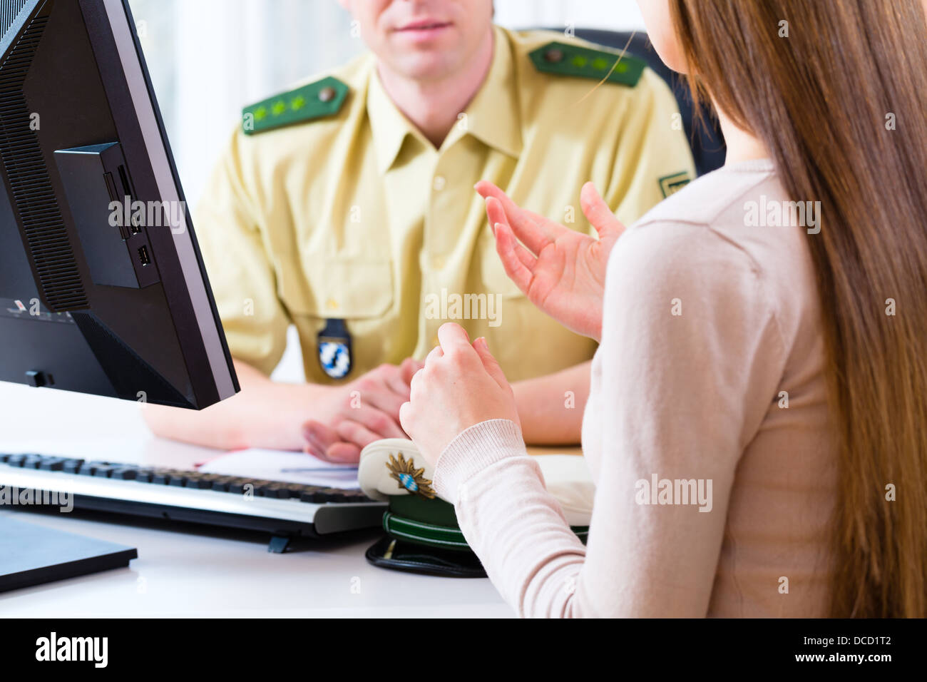 Police officer in police station working on the computer, registering a ...