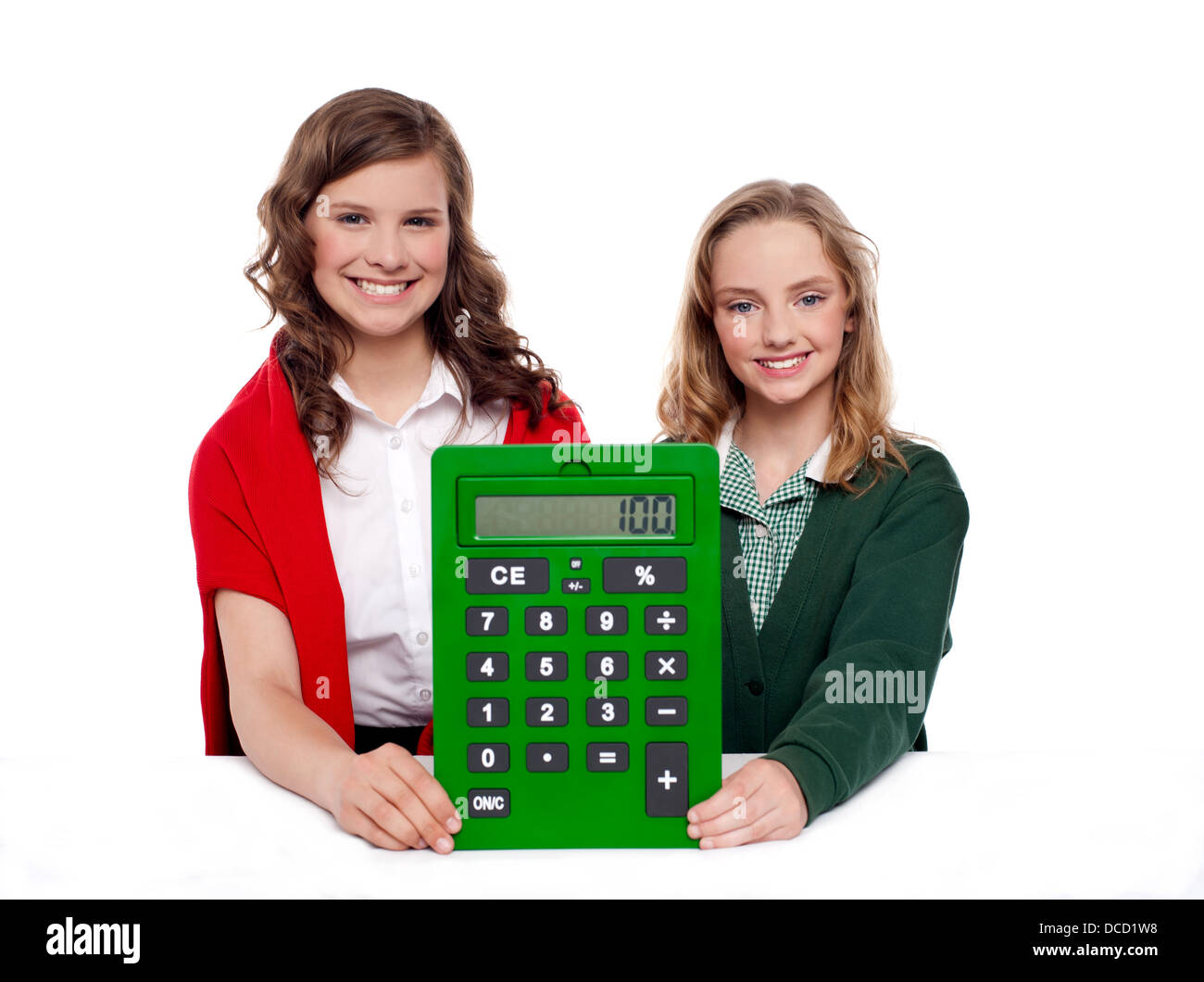 Girls showing big green calculator to camera against white background ...