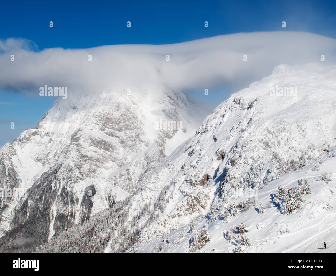 Clouds around mountain peaks during cold winter Stock Photo - Alamy