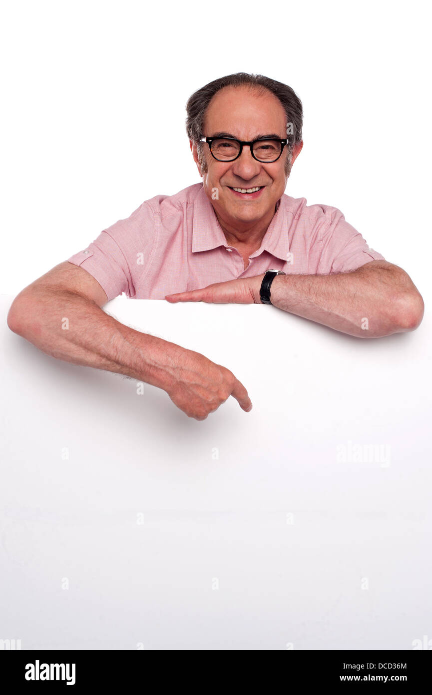 Happy old man pointing at blank billboard isolated over white Stock ...
