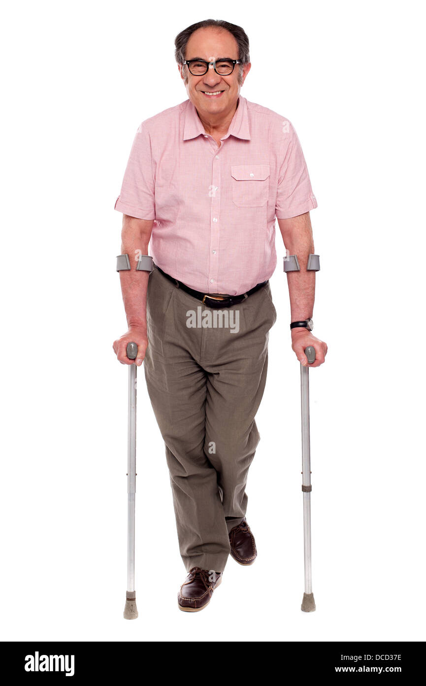 Senior man walking on crutches hi-res stock photography and images - Alamy