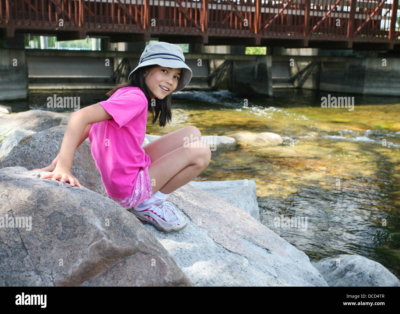Little girl playing on rocks Stock Photo - Alamy