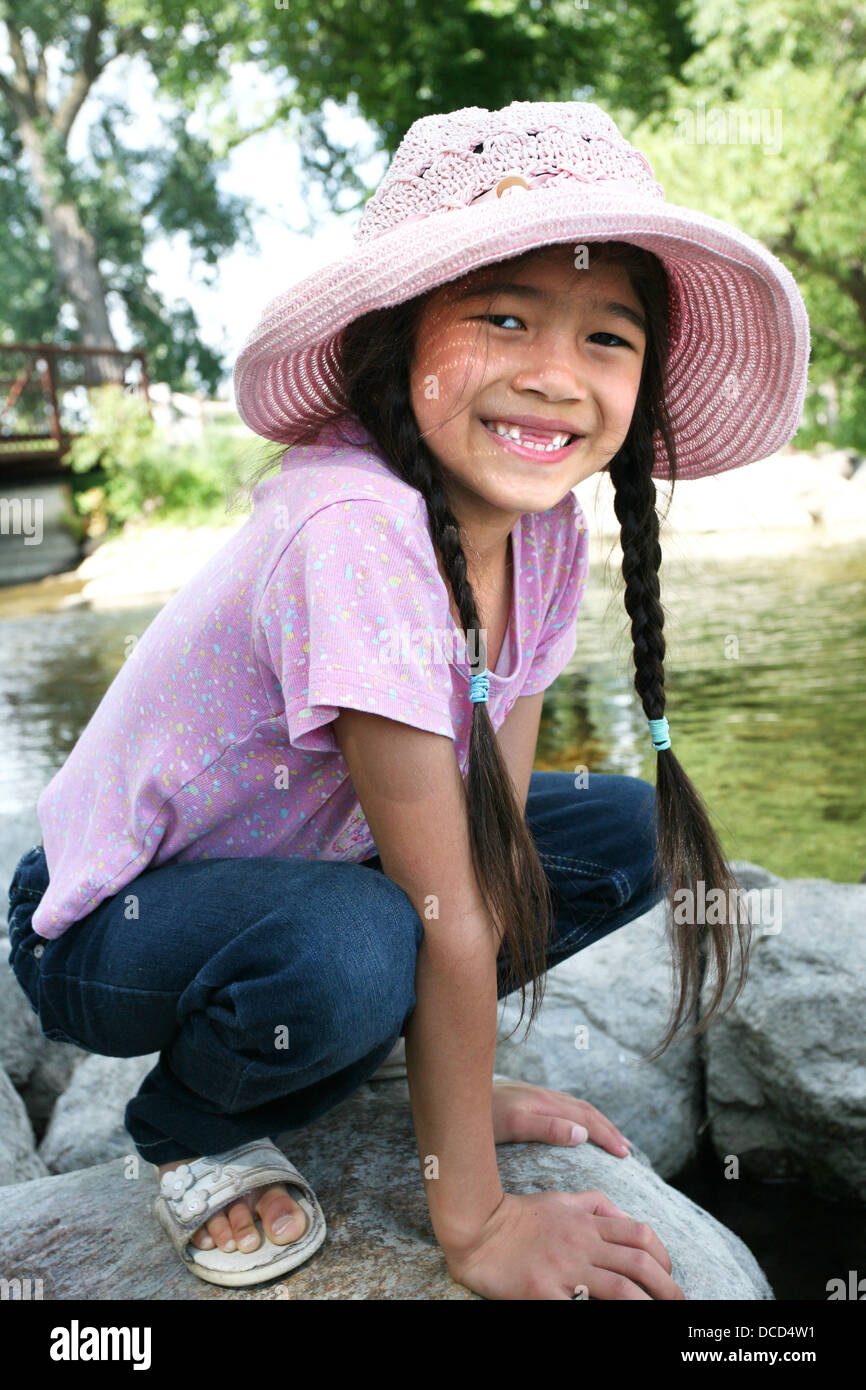 Little girl playing on rocks Stock Photo - Alamy