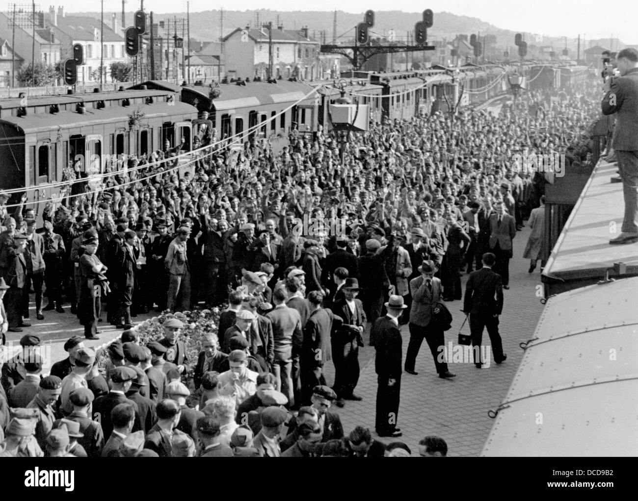 The image shows French civilian workers (on the right) who are about to ...