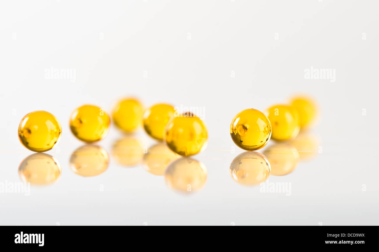 yellow capsules isolated on white Stock Photo - Alamy