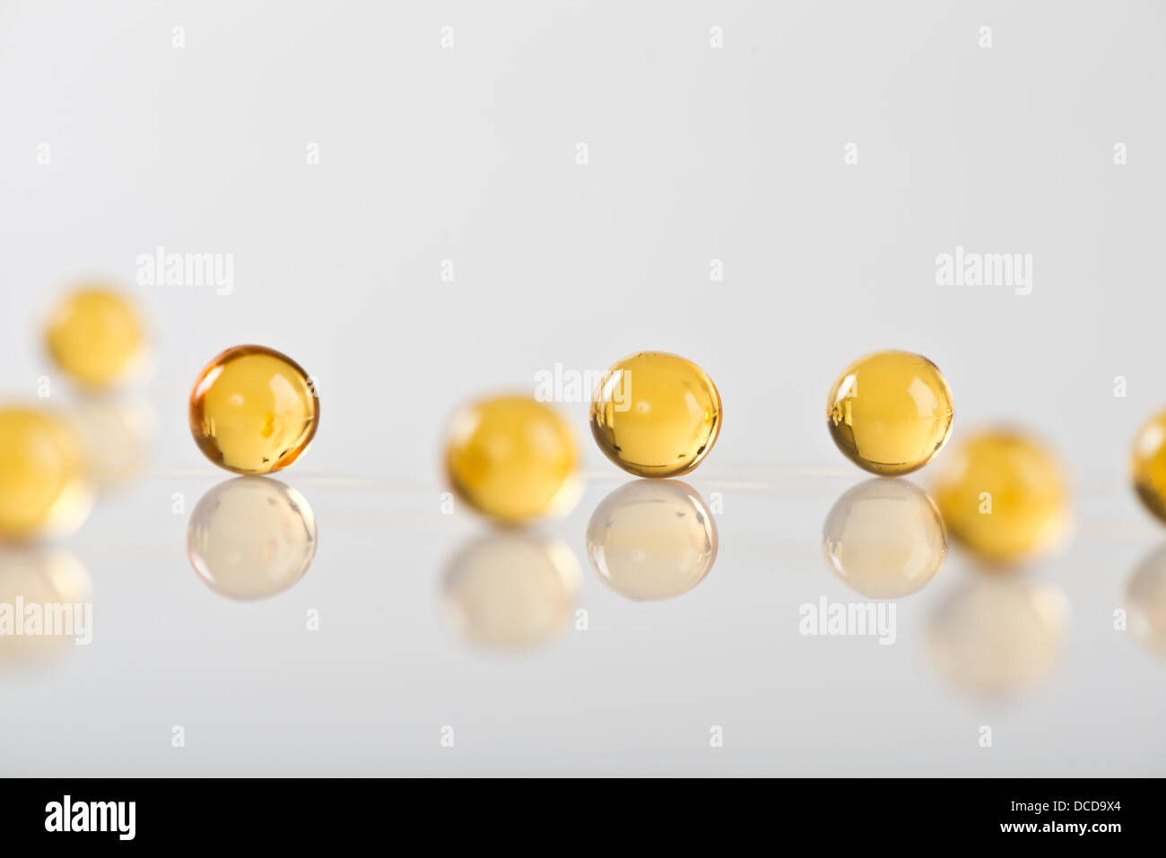 yellow capsules isolated on white Stock Photo - Alamy