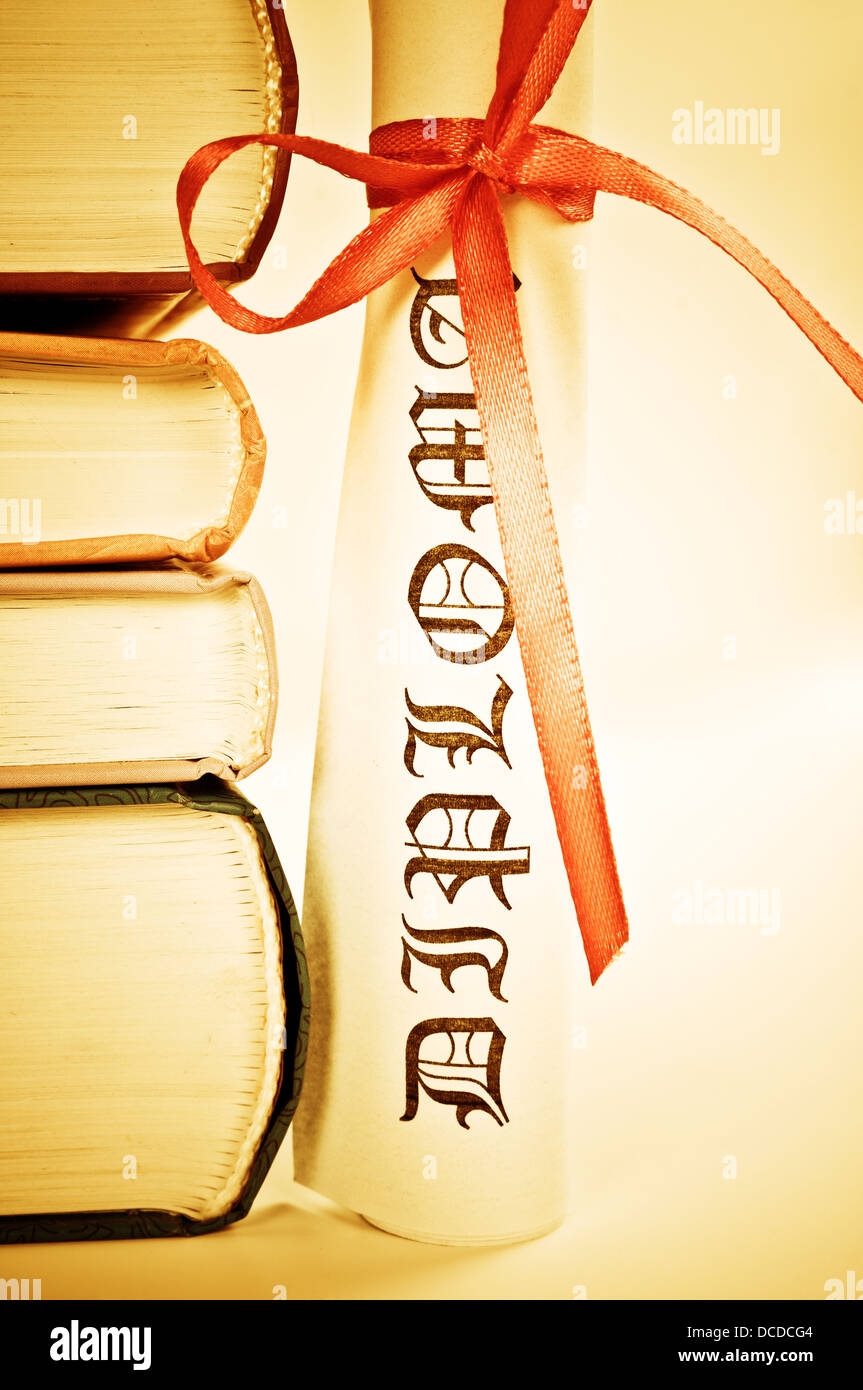 Diploma with red ribbon and books Stock Photo - Alamy