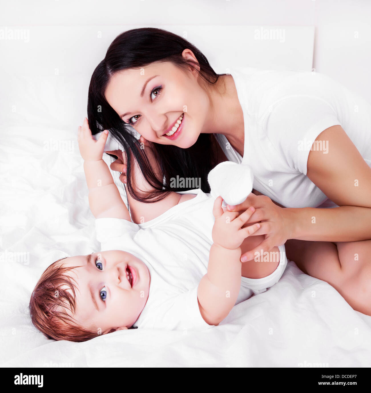 happy young mother with her baby in bed at home Stock Photo - Alamy
