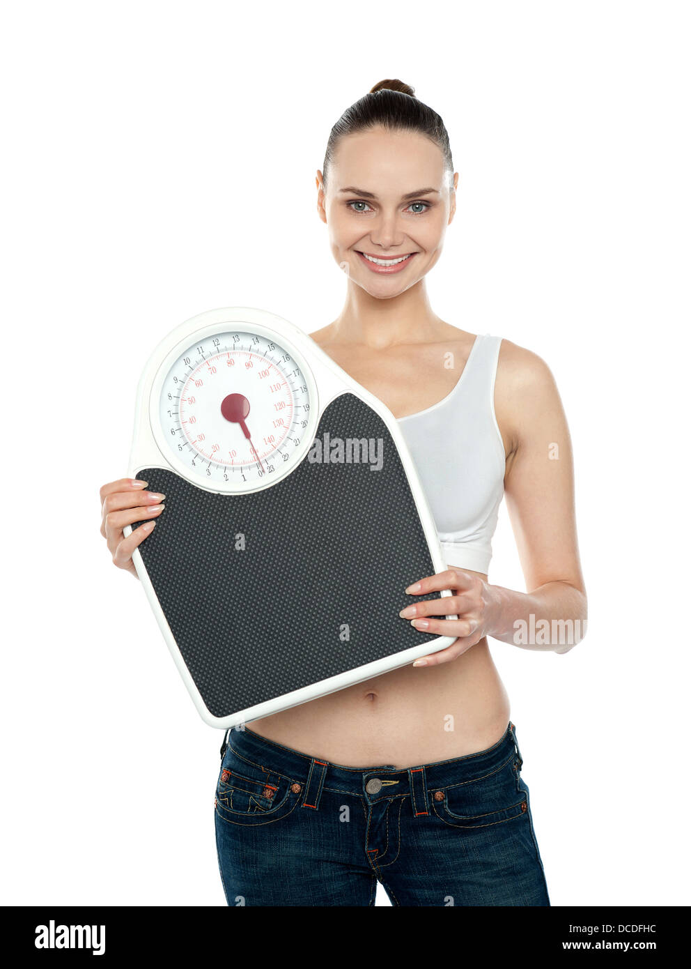 Healthy young woman with a weighing scale isolated over white ...