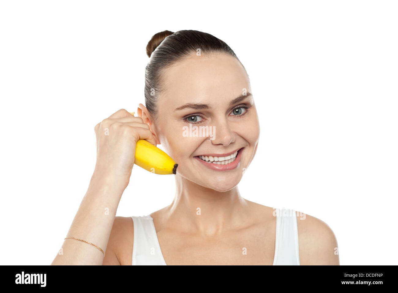 Girl doing call gesture using banana as cellphone. All on white ...