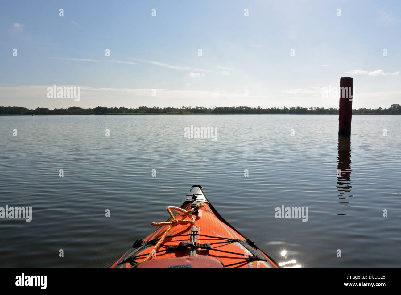 Channel marker post seen in the placid waters of Barton Broad, Norfolk ...