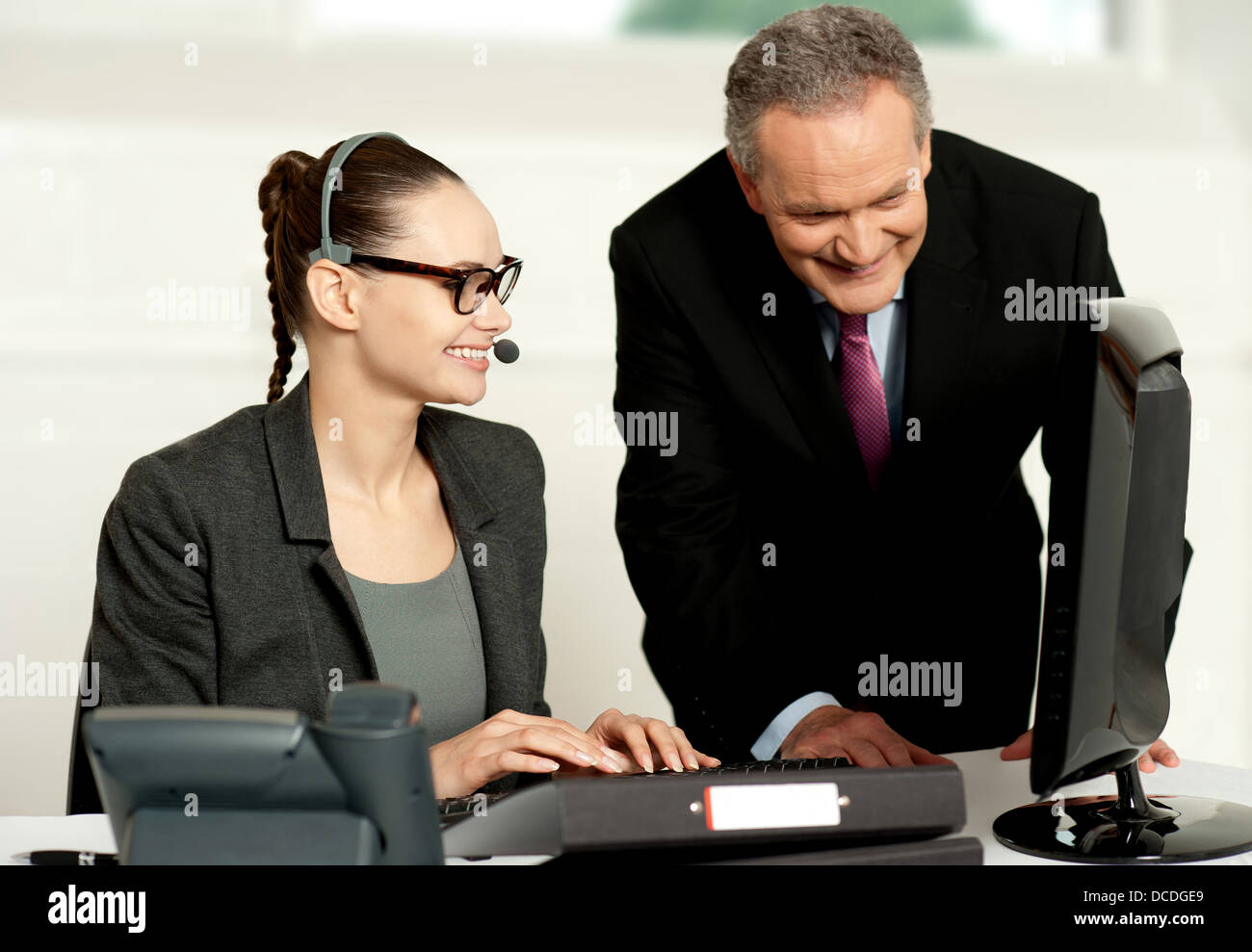 Corporate team working together on computer. Creating database of ...