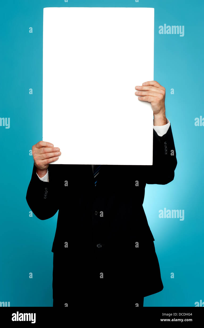 Manager hiding his face behind white banner ad isolated on gradient ...