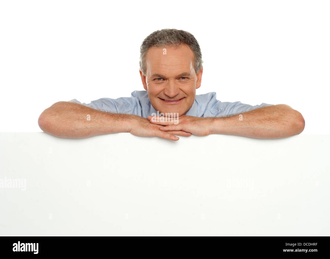 Smiling man behind blank white banner ad looking at you Stock Photo - Alamy
