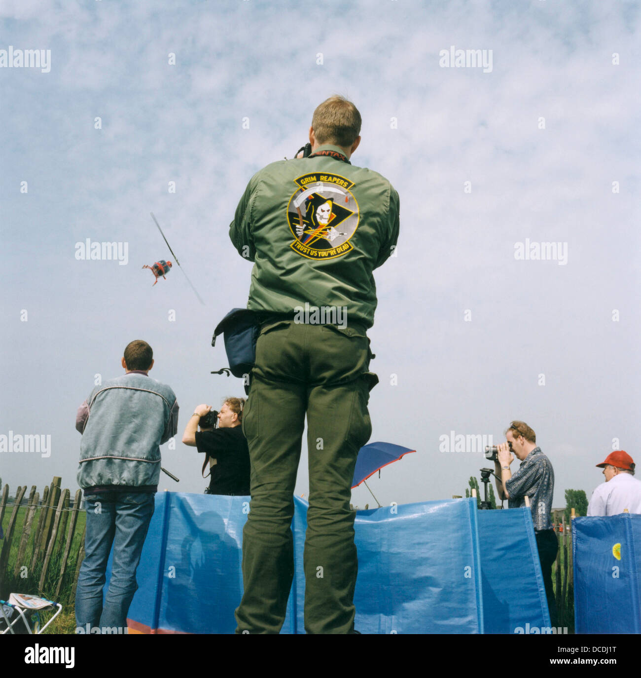 An airshow aviation enthusiast adorned with badges enjoy aerobatic ...