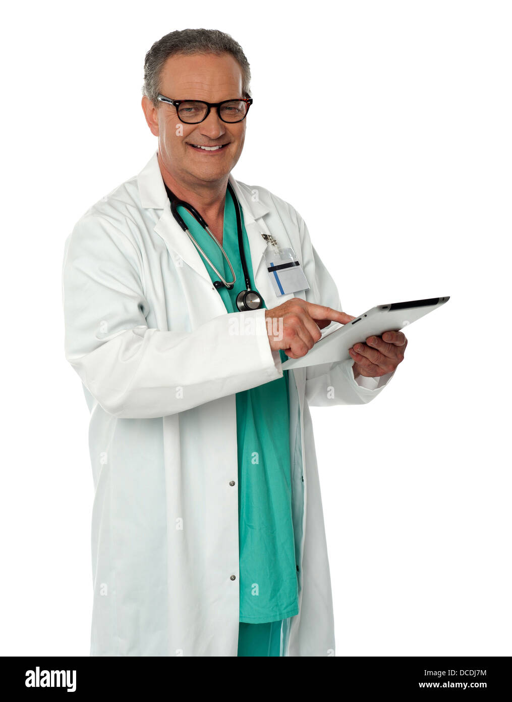 Cheerful doctor using wireless tablet device looking at you Stock Photo ...