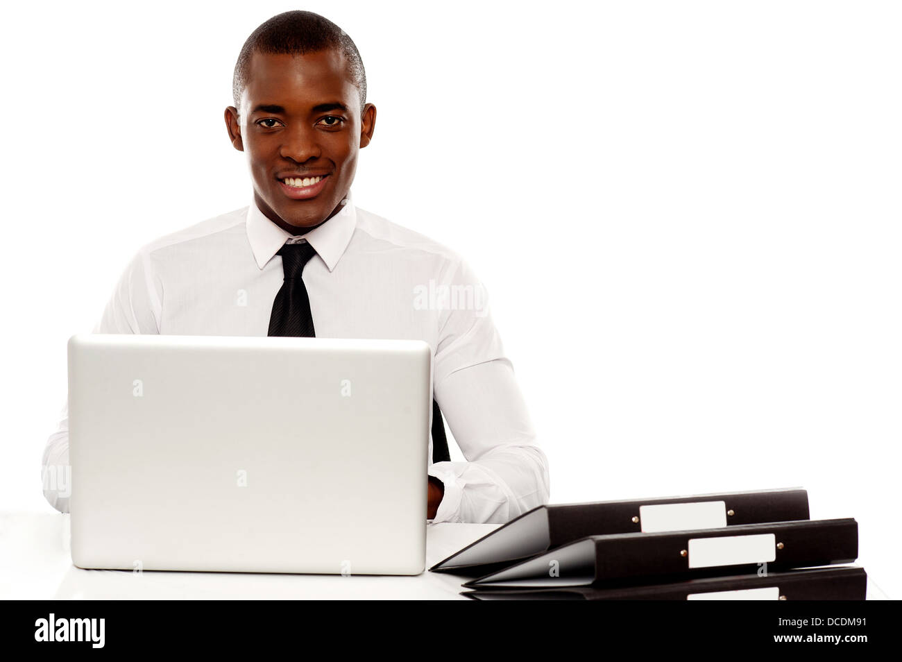 African corporate male manager at work desk using laptop and looking at ...