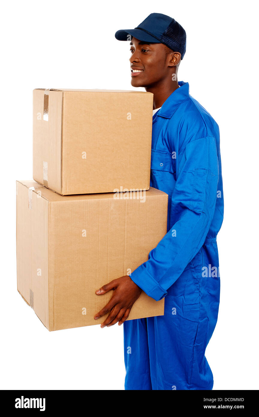 Young courier boy moving boxes looking away. Great services Stock Photo ...