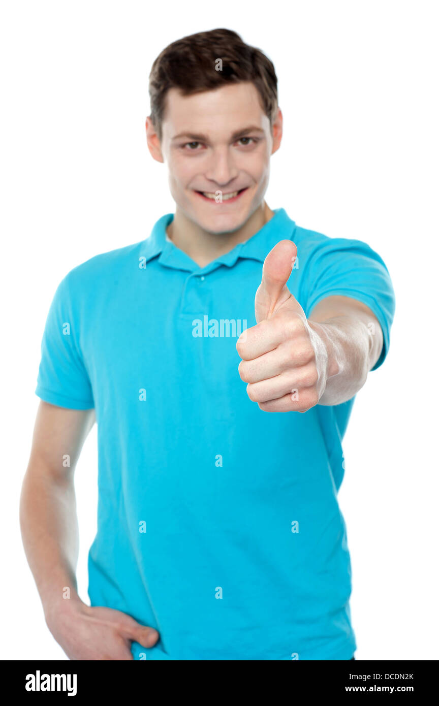 Handsome casual smiling guy showing thumbs up to camera isolated ...
