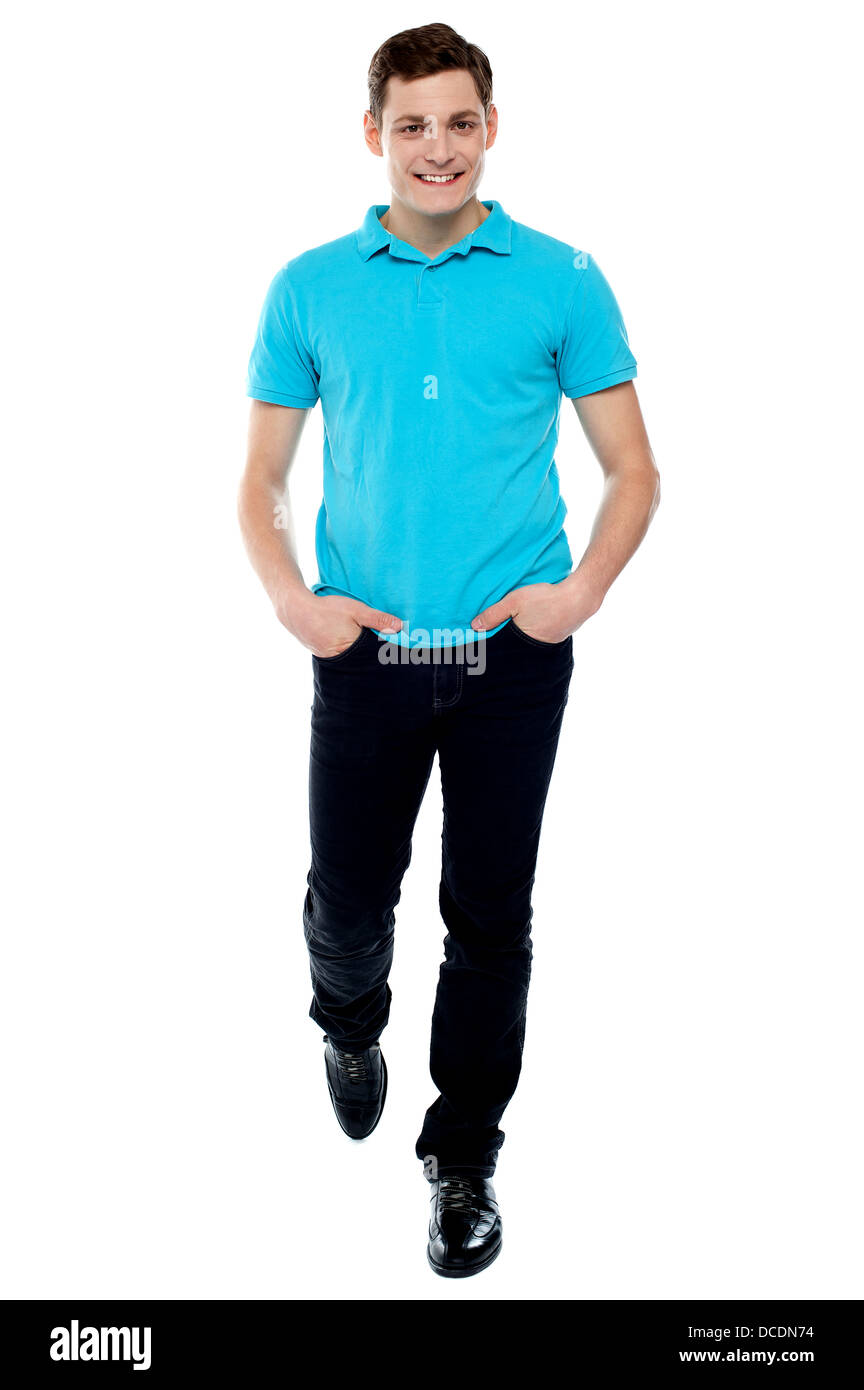 Handsome guy in walking pose. Studio shot over white background Stock ...