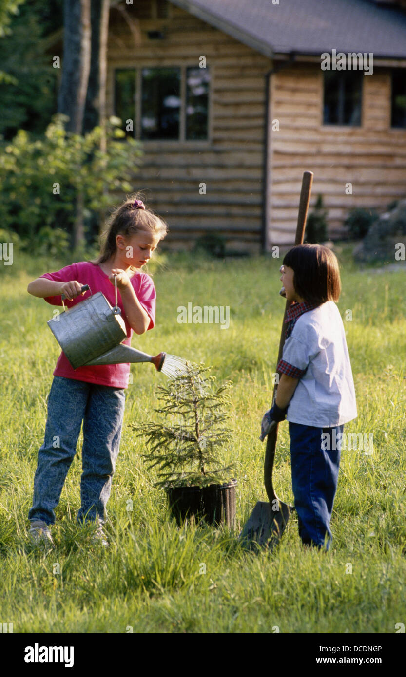 Two female girls planting hi-res stock photography and images - Alamy