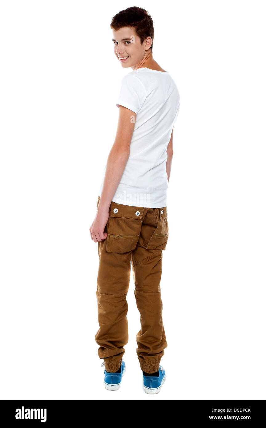 Trendy young boy turning back and smiling at camera Stock Photo - Alamy