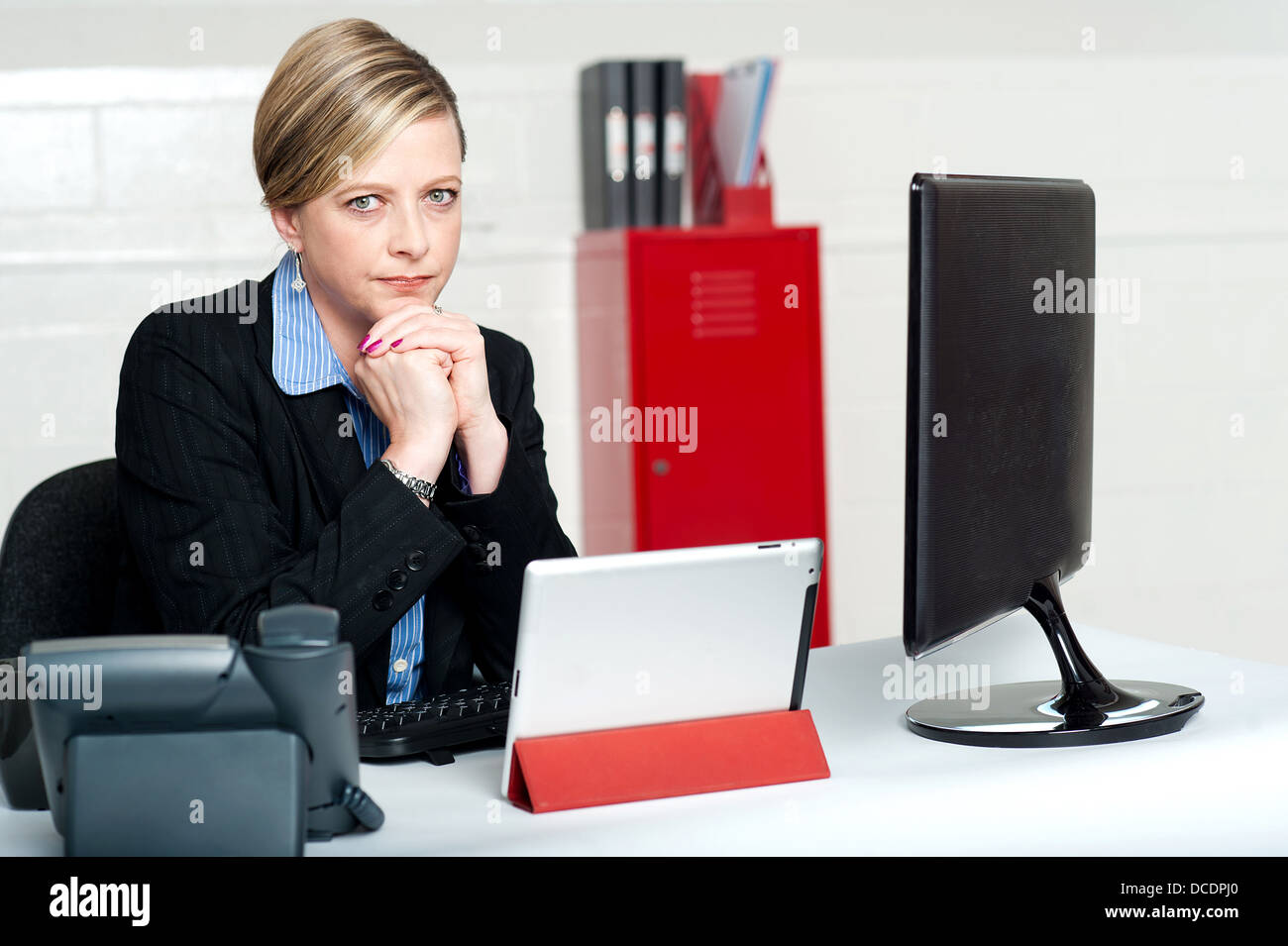 Serious business lady looking right into camera. Thinking hard in mind ...