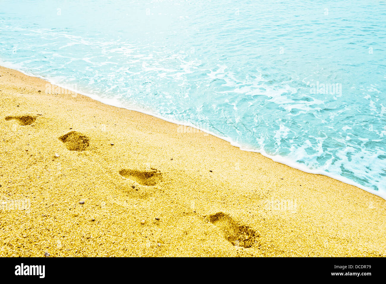 Footprint on sand with foam Stock Photo - Alamy