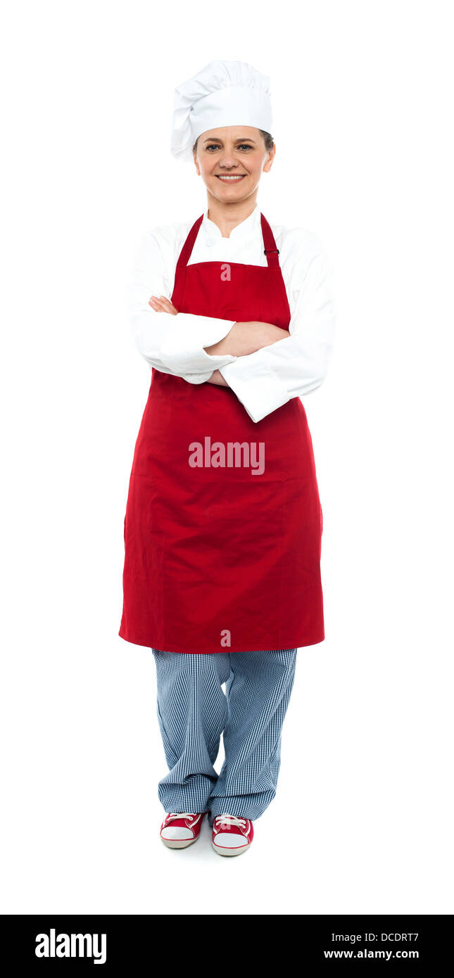 Beautiful aged female chef posing in uniform with arms crossed, full ...