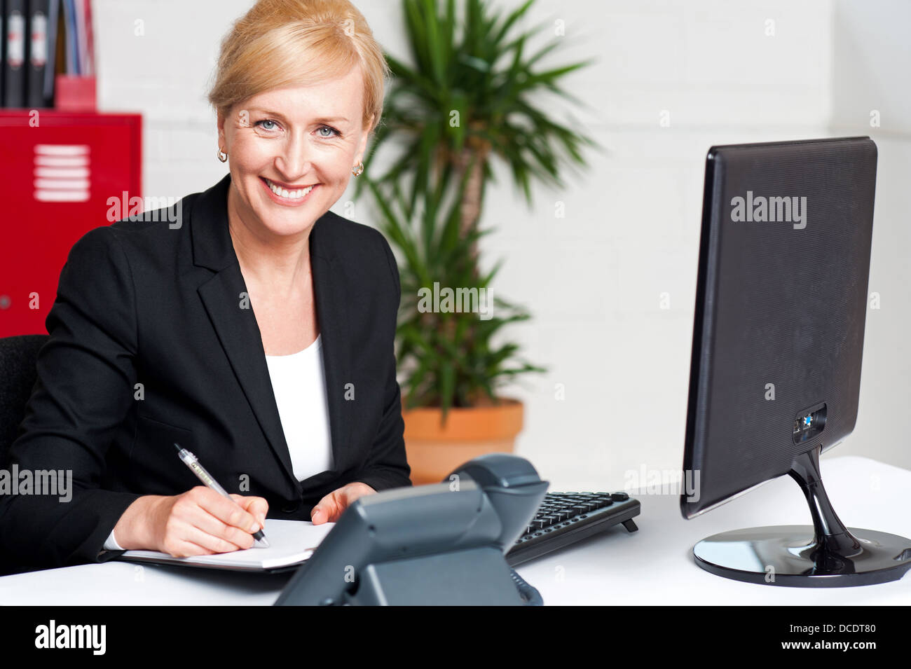 Smiling business executive preparing her schedule Stock Photo - Alamy