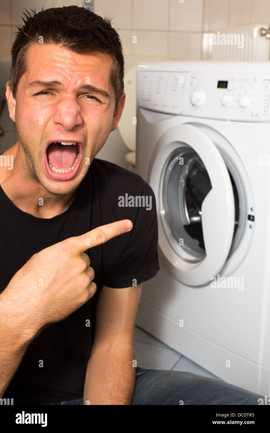 Man crazy at washing machine Stock Photo - Alamy