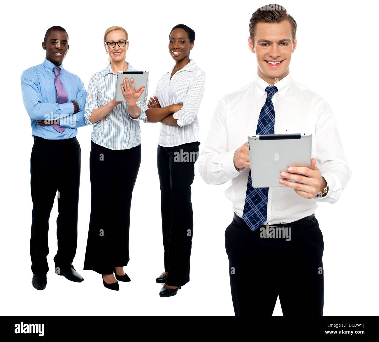 Handsome male executive operating tablet while colleagues discussing in ...