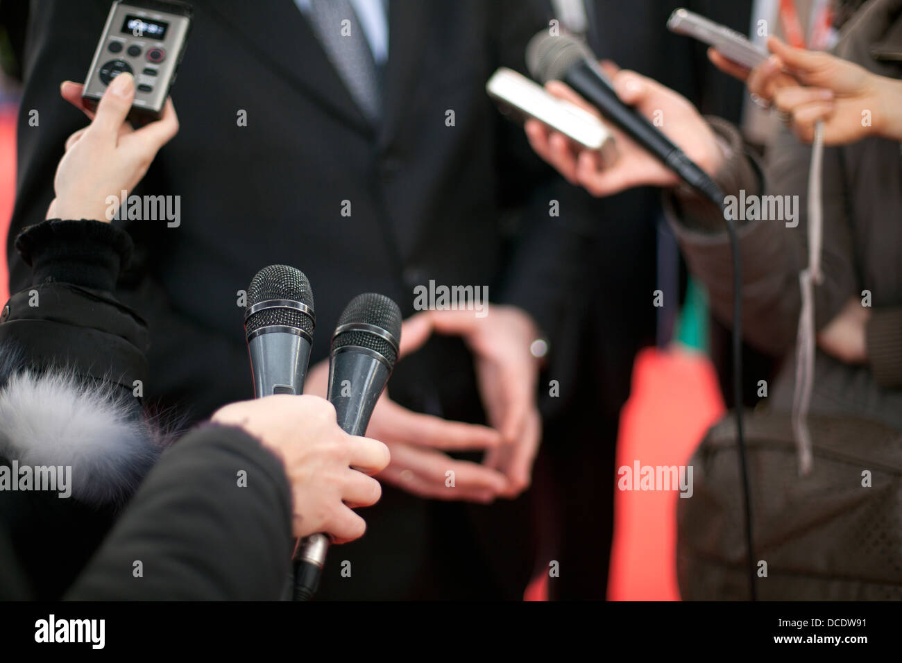 A journalist is making a interview with a microphone Stock Photo - Alamy
