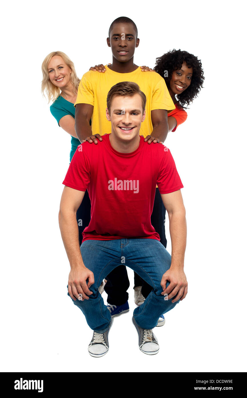 Young people standing behind semi seated guy. African guy resting hands ...