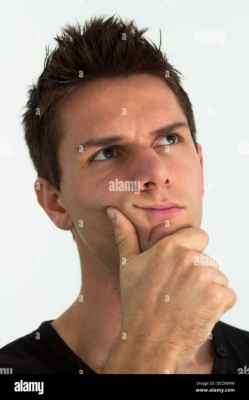 Man thinking with hand on face Stock Photo - Alamy