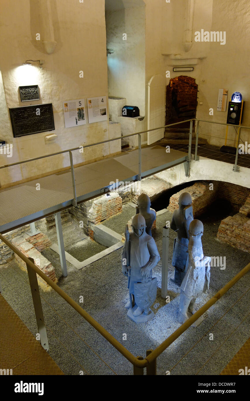 The four stone tower guards inside the belfry museum in the historic ...