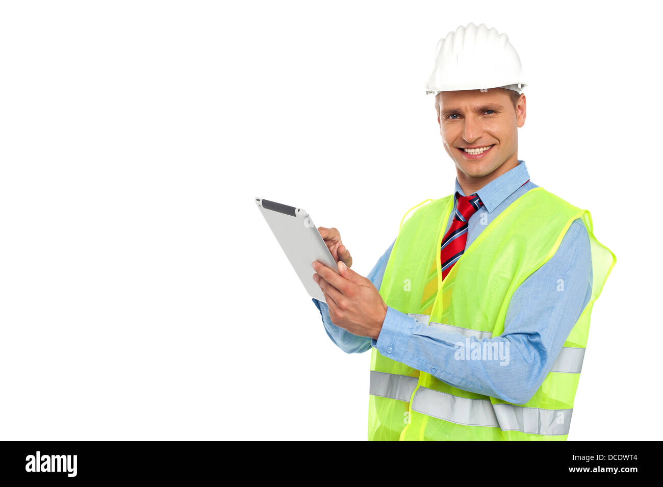 Construction engineer wearing safety hat and operating wireless device ...