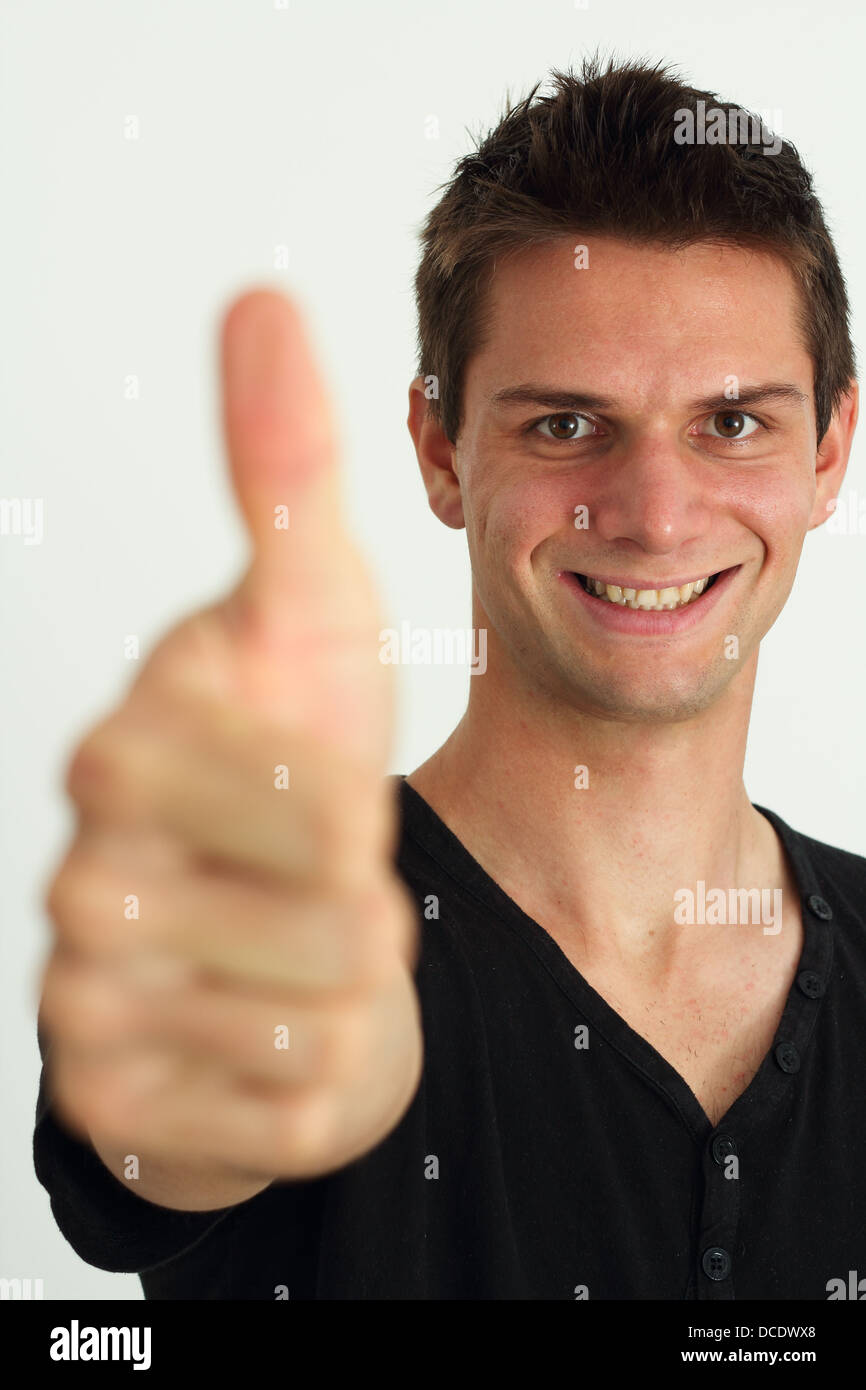 Happy smiling man doing two thumbs up Stock Photo - Alamy