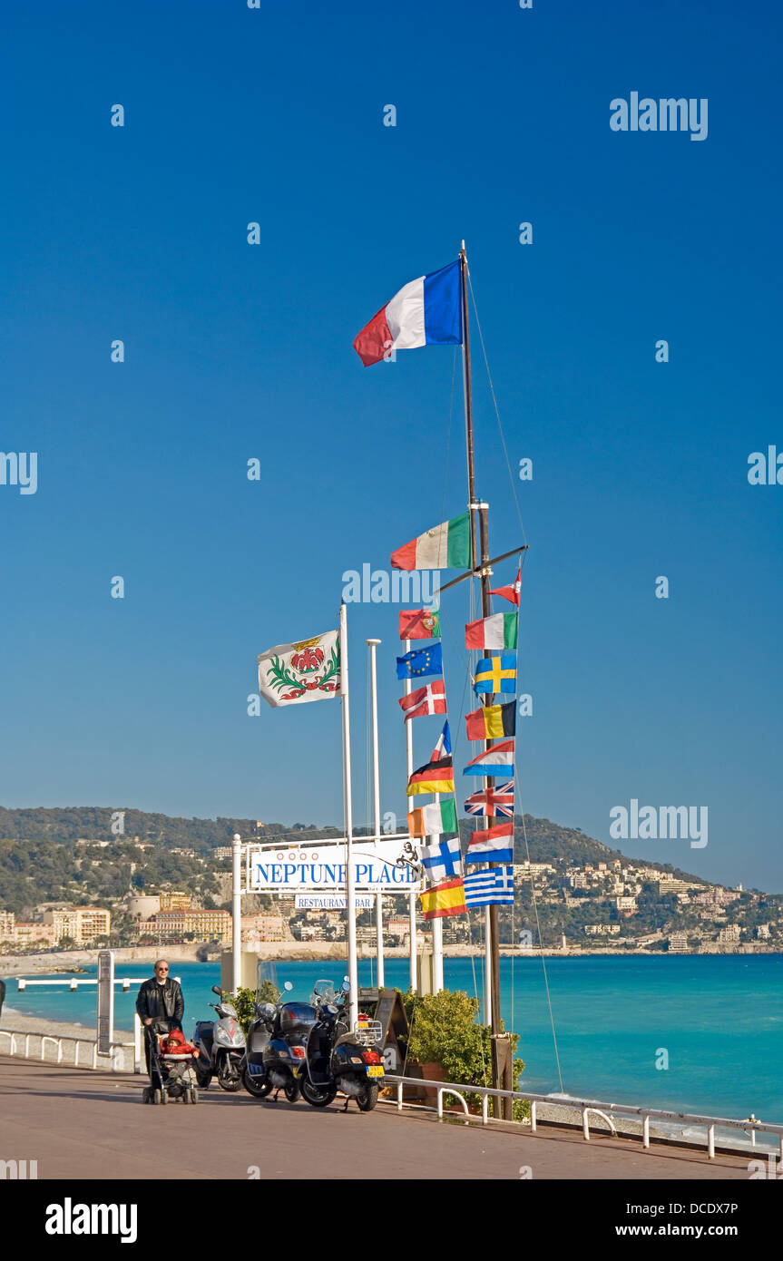 Flags of many nations against the blue sky on the Promenade des Anglais ...