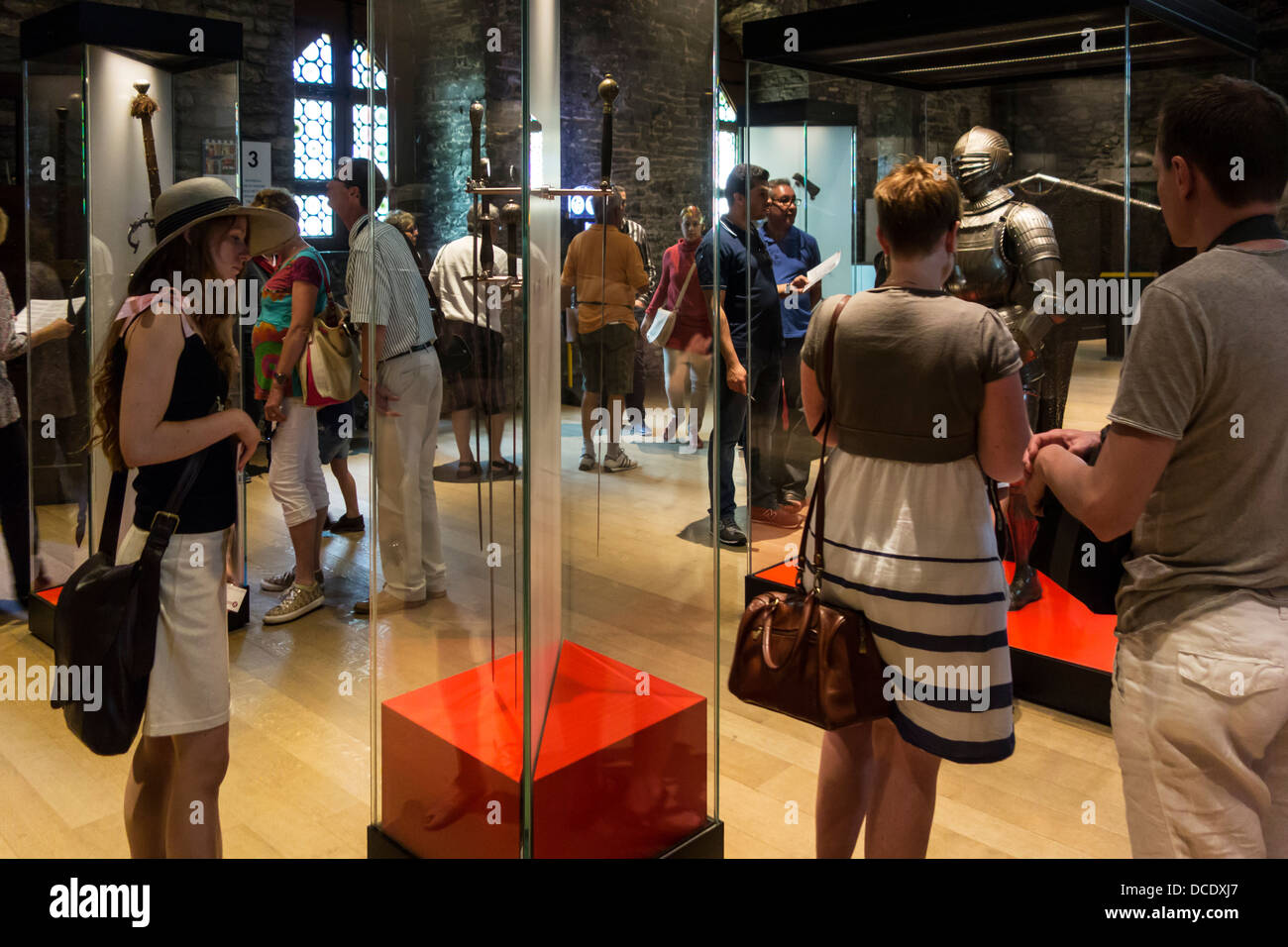 Tourists looking at medieval weapons and swords in the Gravensteen ...