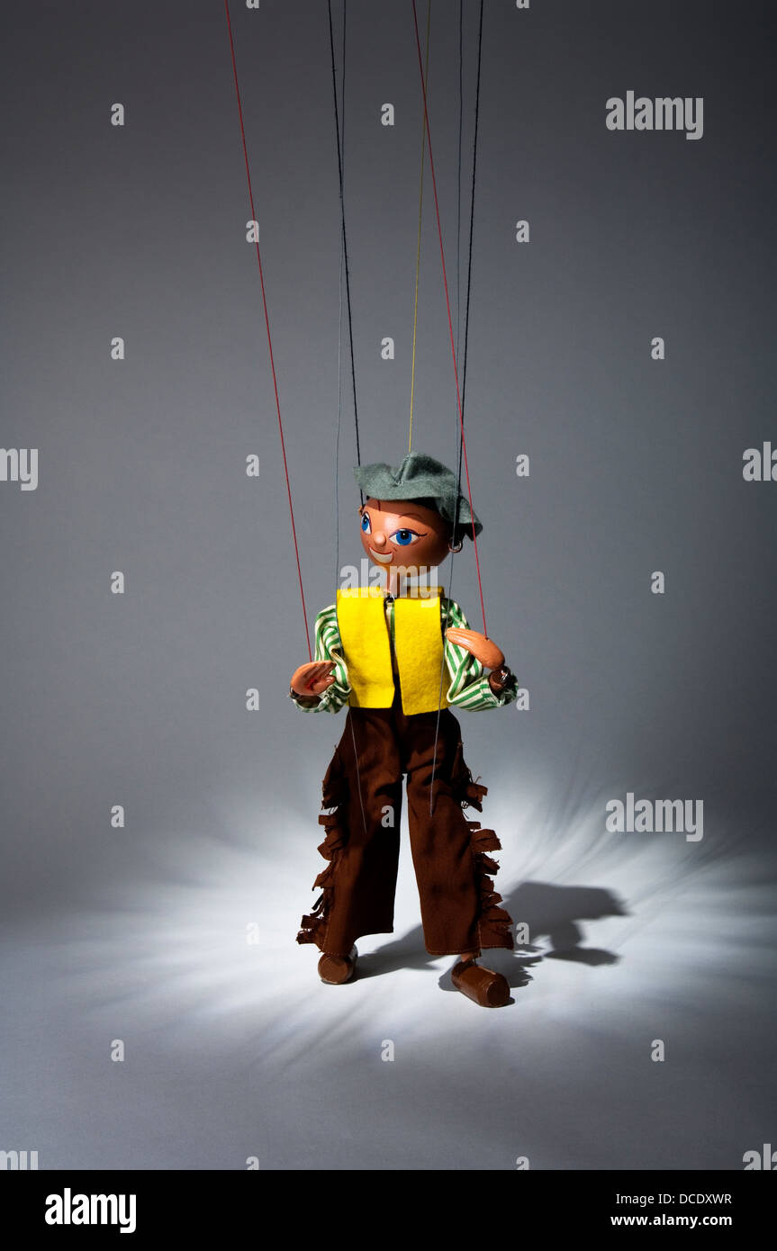 A marionette puppet dressed as Tex the cowboy, in the spotlight Stock ...