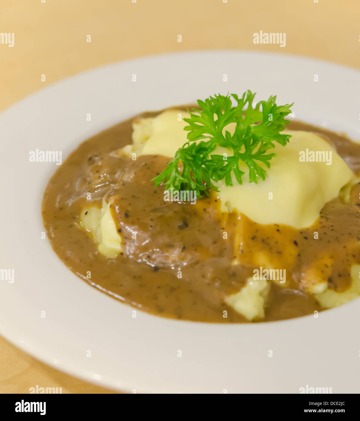 close up Mashed potato with gravy poured on white dish Stock Photo - Alamy