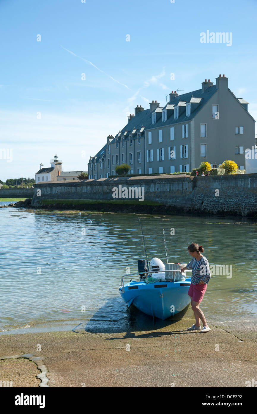 Woman with boat on the quayside Barfleur Normandy France Stock Photo ...